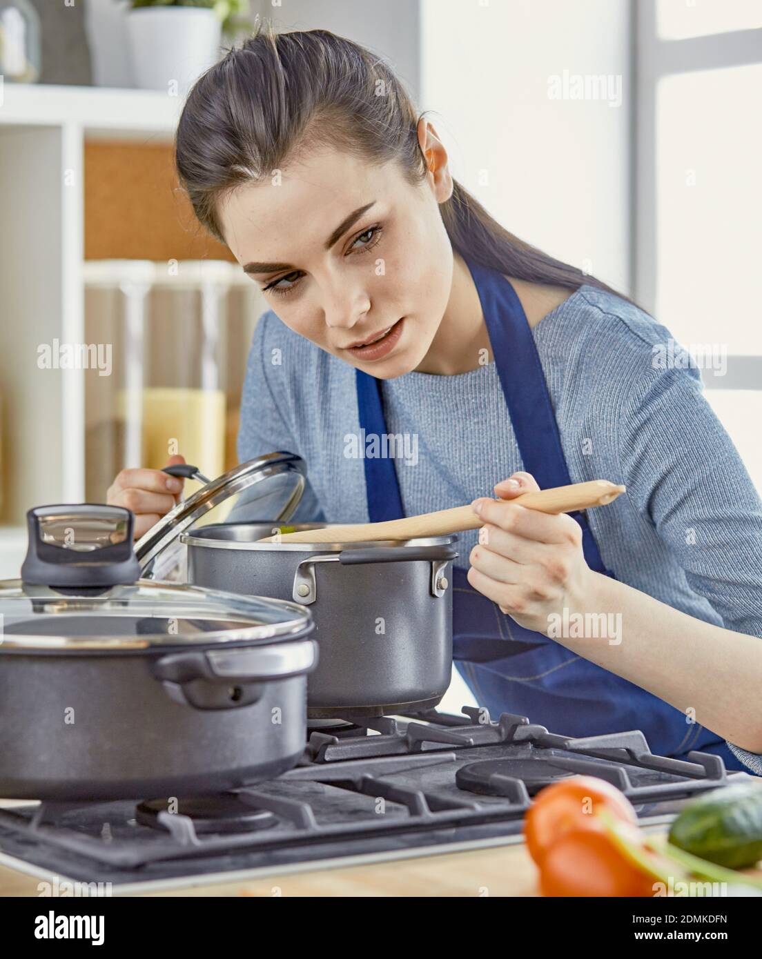 Beautiful woman in the kitchen, waiting with the front of the o Stock ...