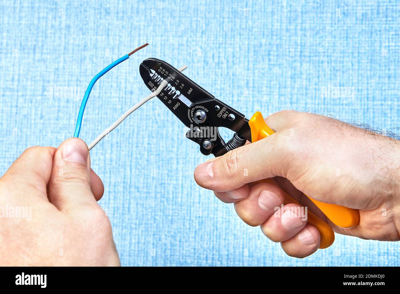 Human hand cutting blue wire hi-res stock photography and images - Alamy
