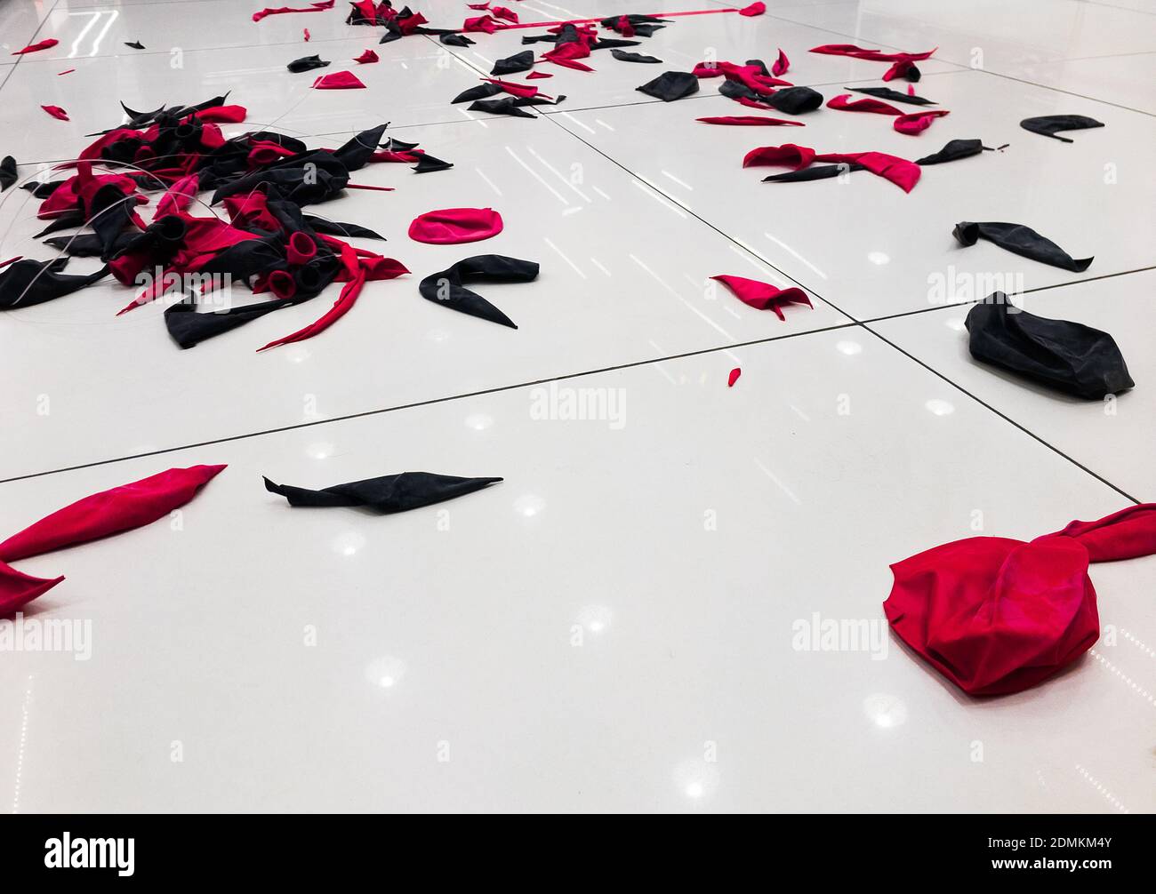 bursted balloons on floor after party Stock Photo - Alamy