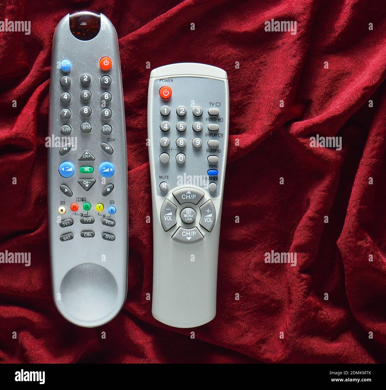 TV remote controls on a red silk background Stock Photo - Alamy