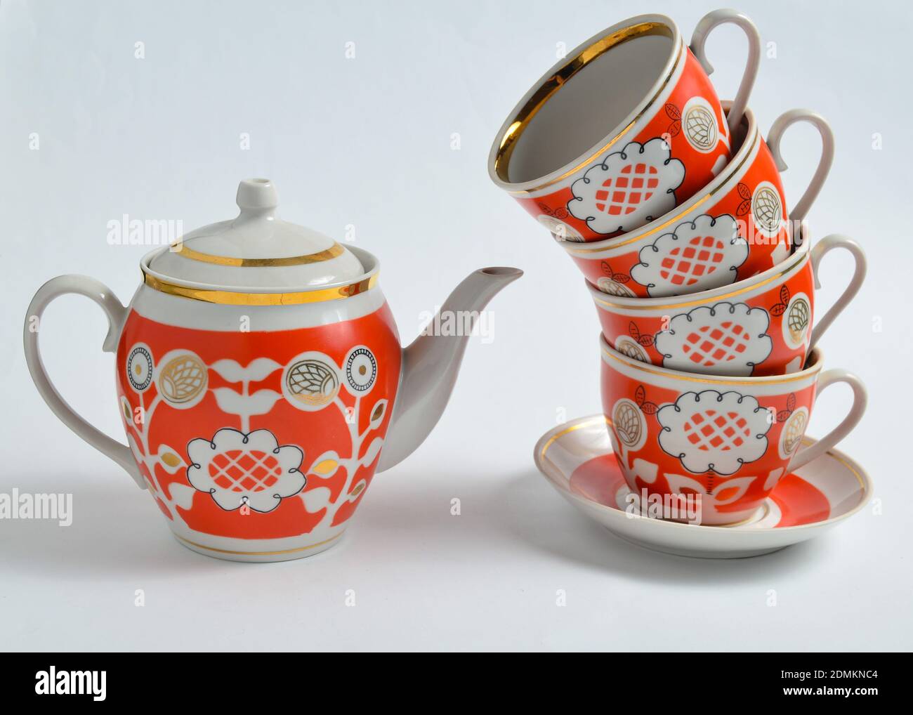 Stack of retro cups and teapot on a white background Stock Photo - Alamy