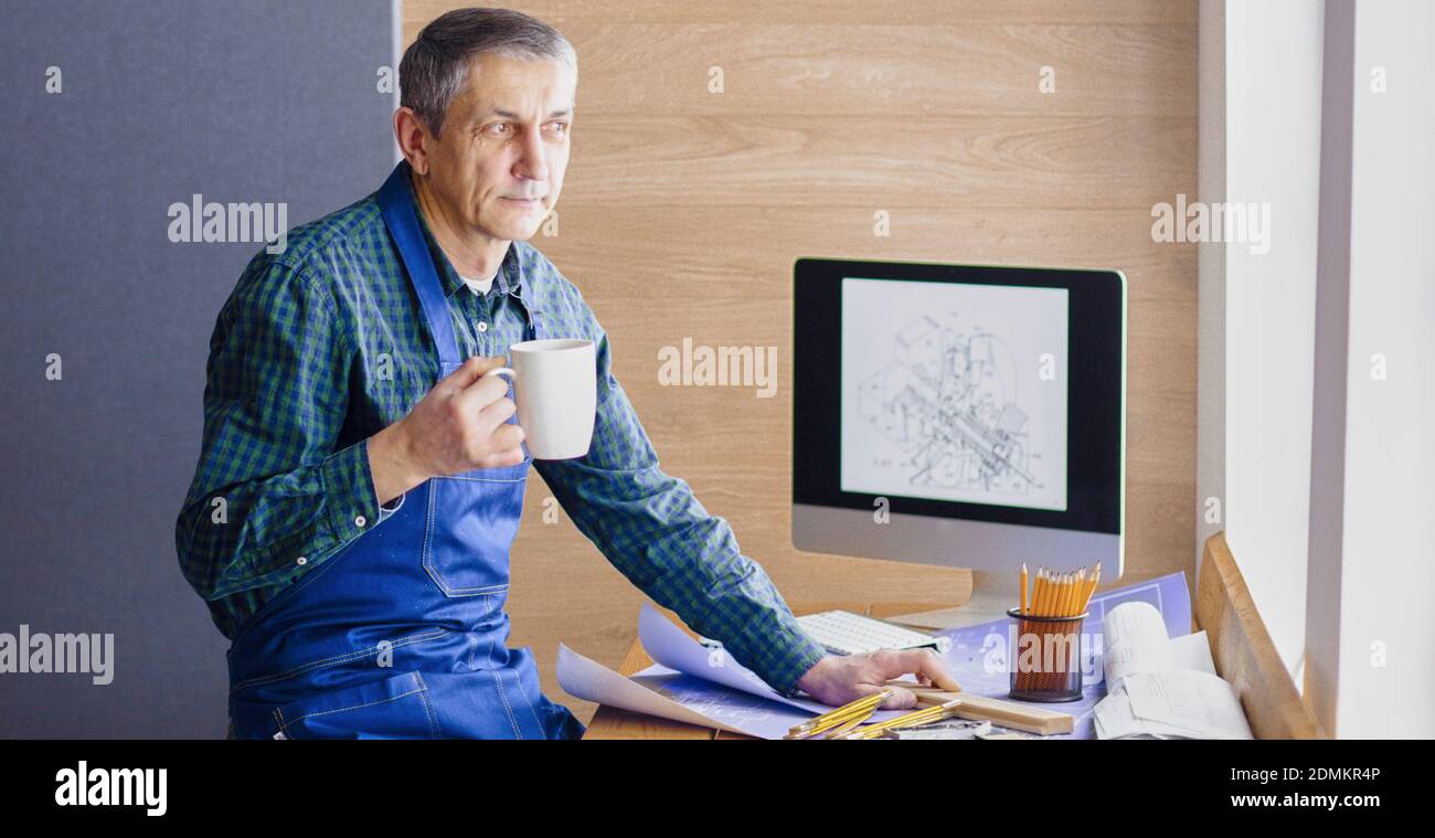 Engineer carpenter working on laptop and sketching project Stock Photo ...