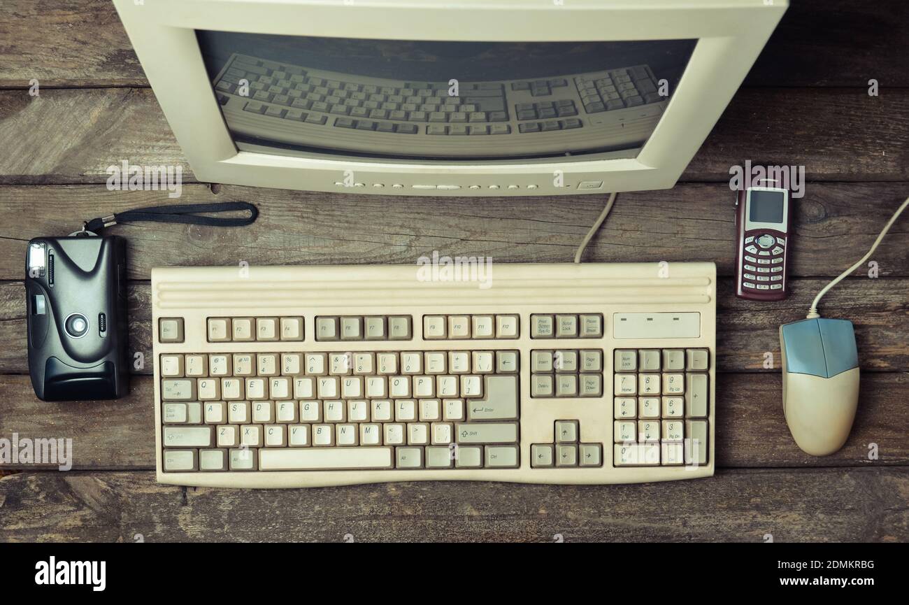 Retro stationary computer on a rustic wooden desk, vintage workspace ...