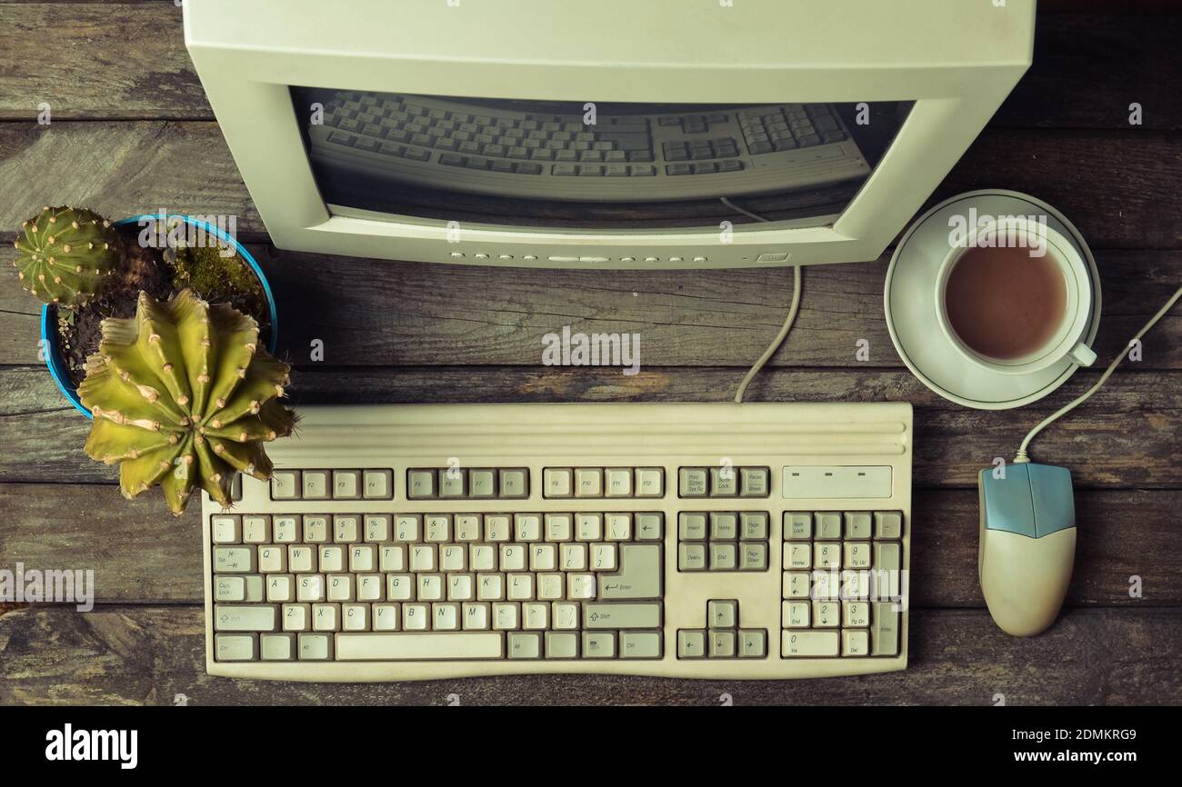 Retro stationary computer on a rustic wooden desk, vintage workspace ...