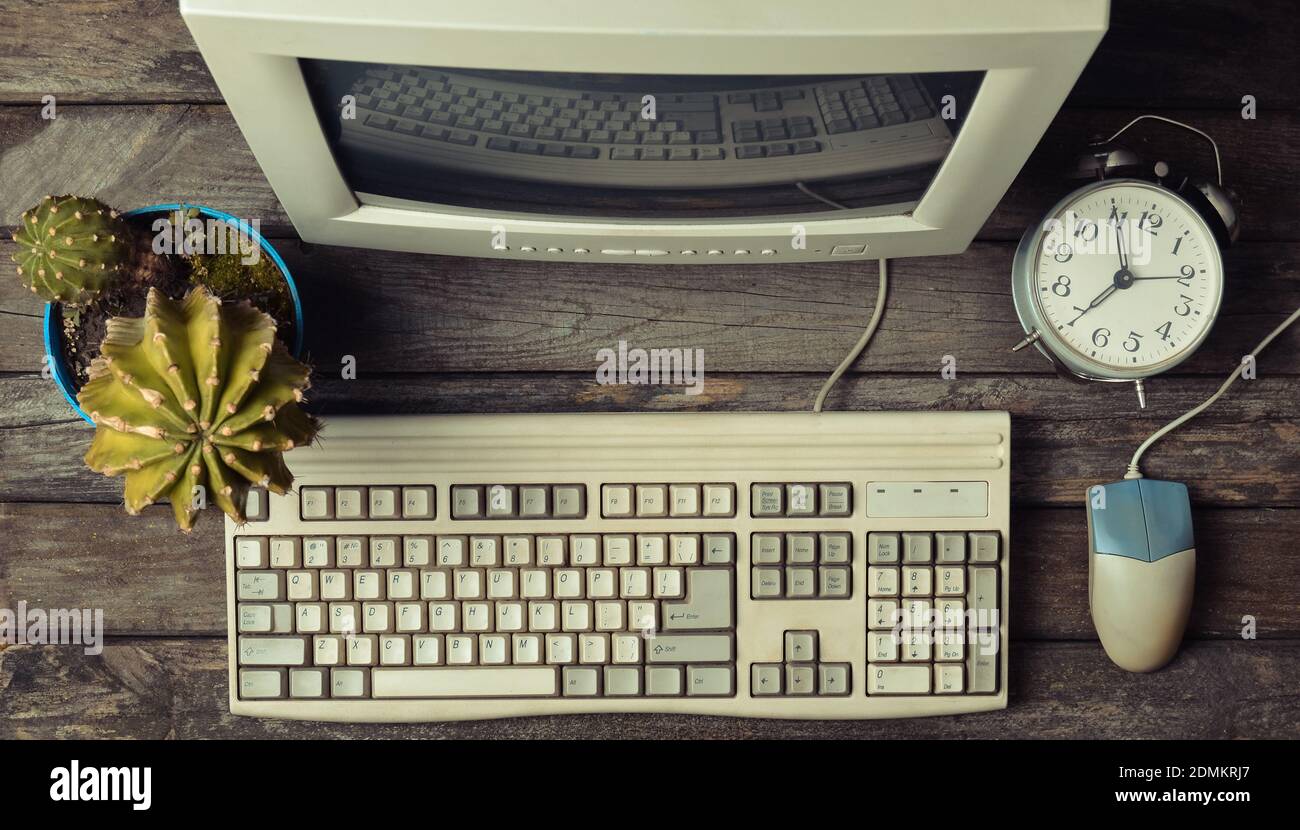Retro stationary computer on a rustic wooden desk, vintage workspace ...