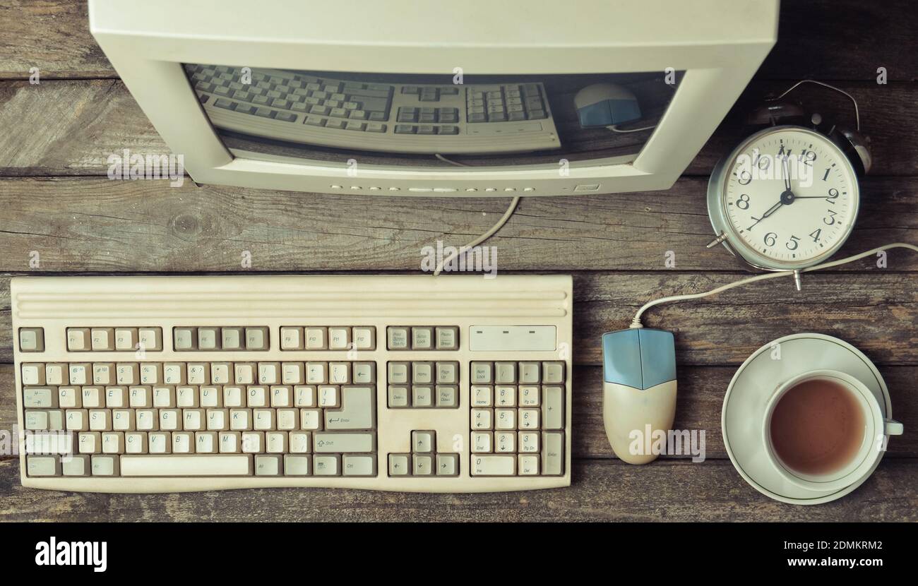 Retro stationary computer on a rustic wooden desk, vintage workspace ...
