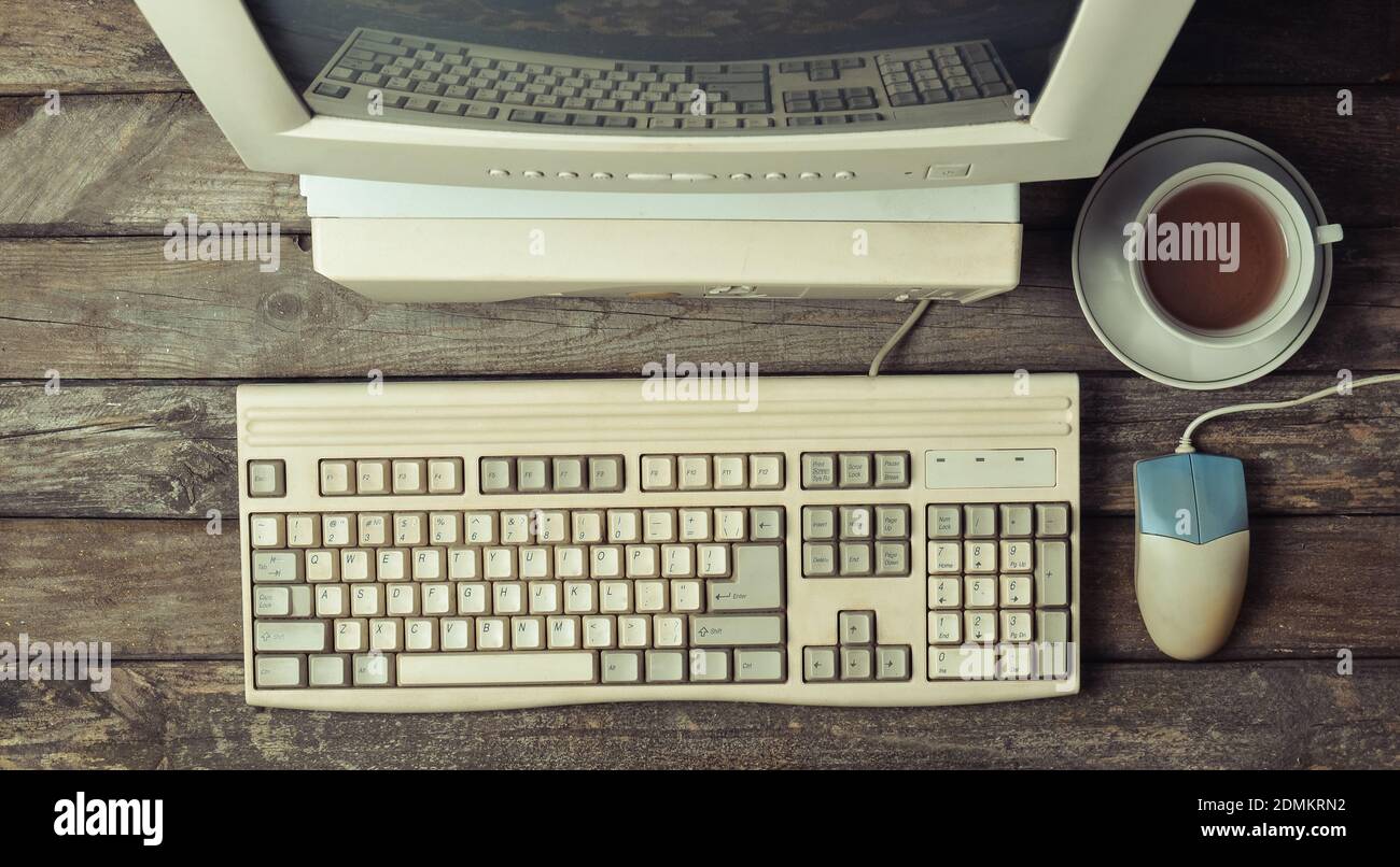 Retro stationary computer on a rustic wooden desk, vintage workspace ...