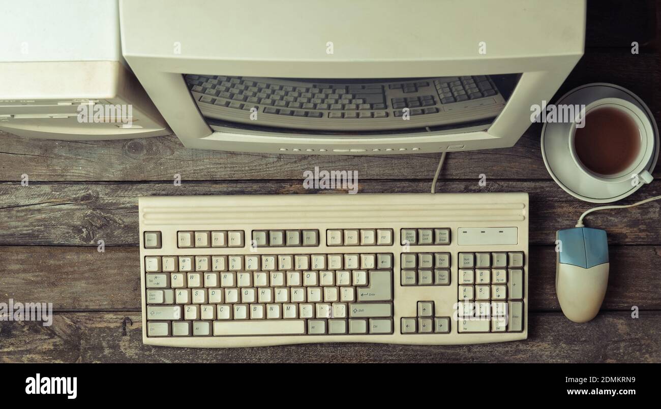 Retro stationary computer on a rustic wooden desk, vintage workspace ...