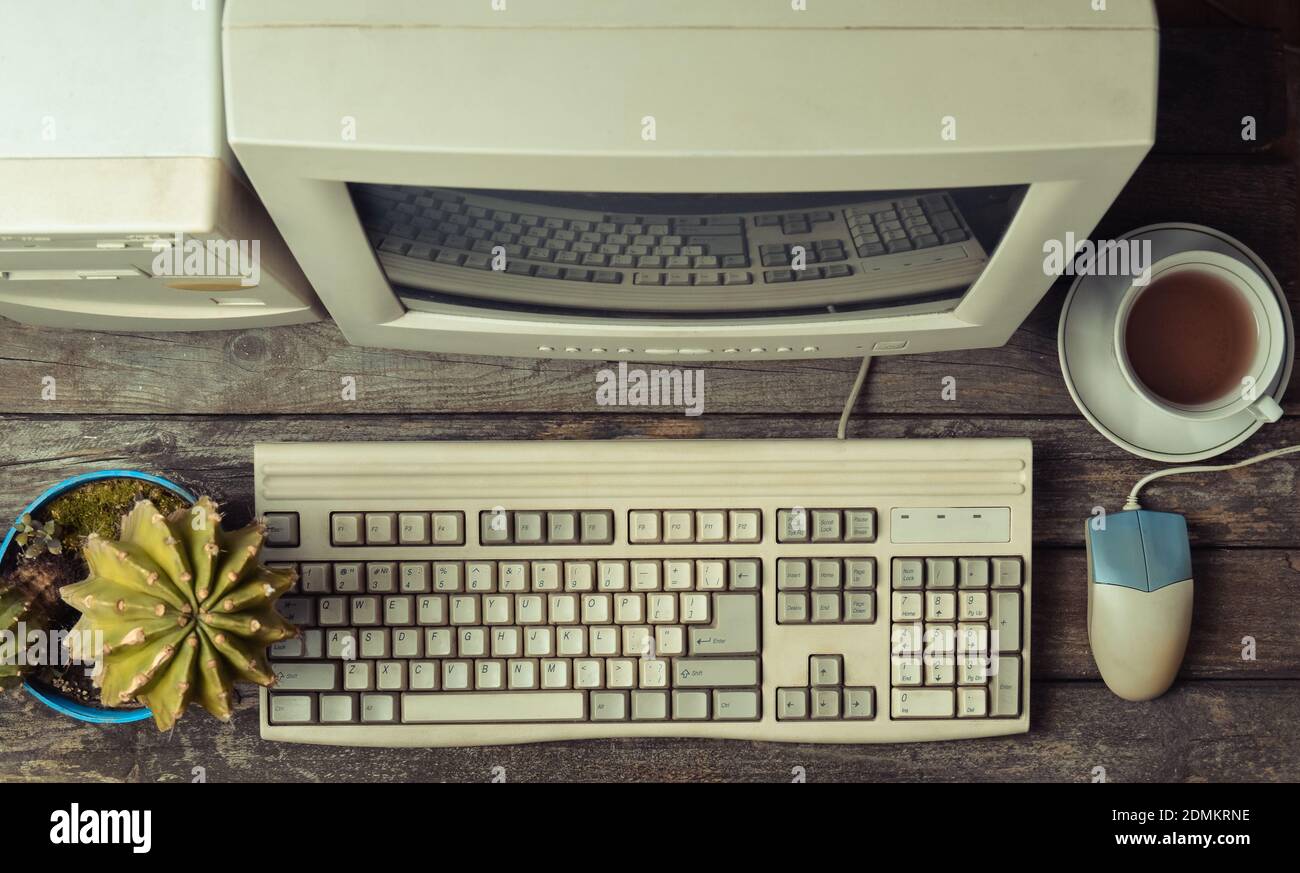 Retro stationary computer on a rustic wooden desk, vintage workspace ...