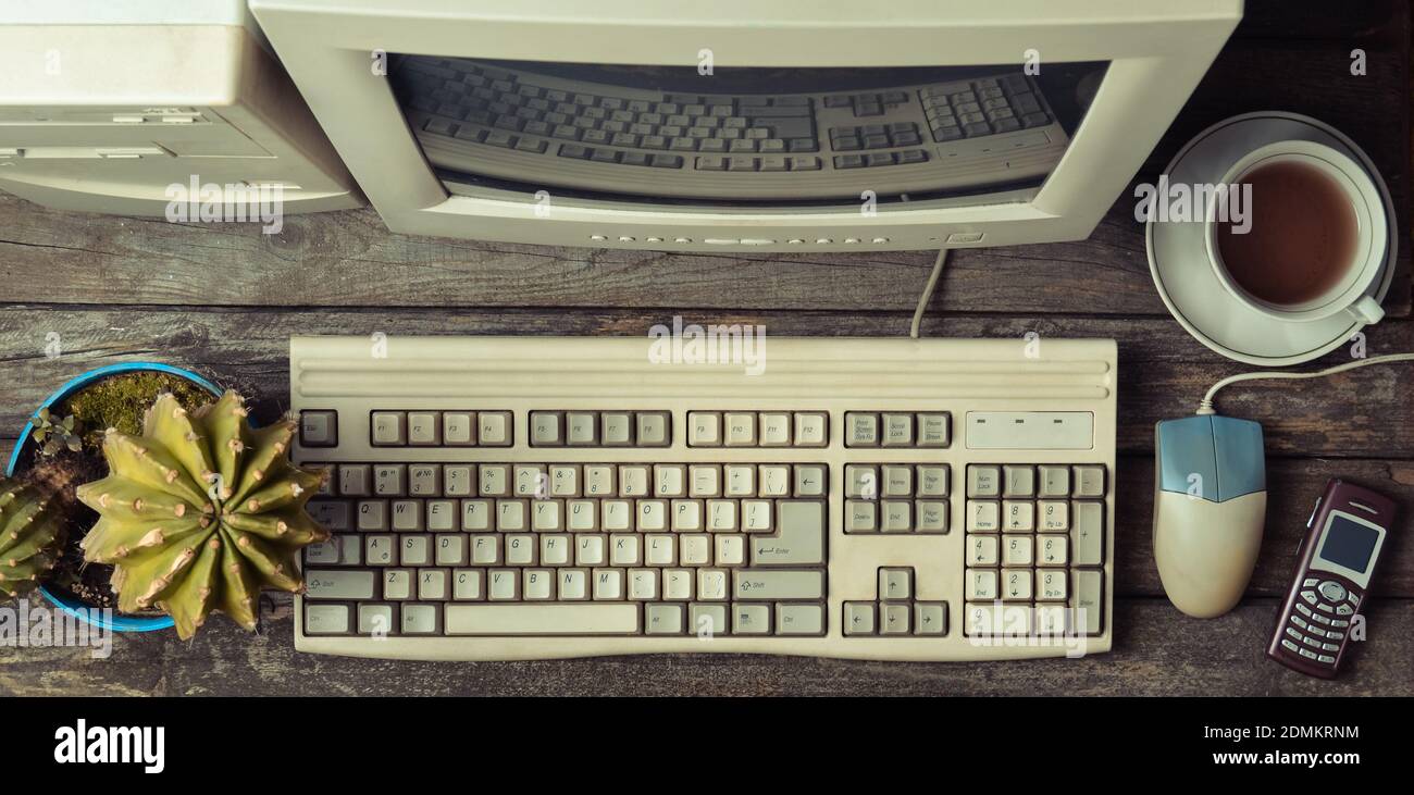 Retro stationary computer on a rustic wooden desk, vintage workspace ...