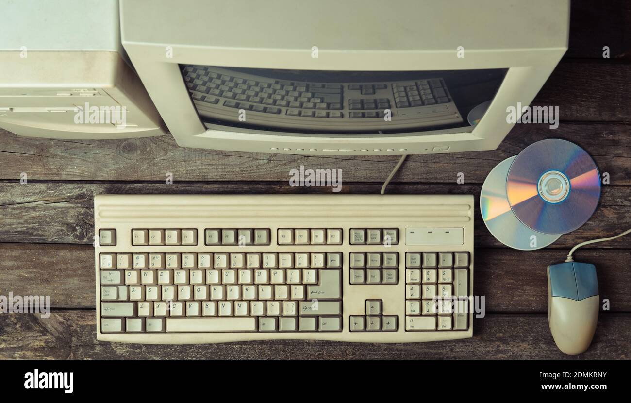 Retro stationary computer on a rustic wooden desk, vintage workspace ...