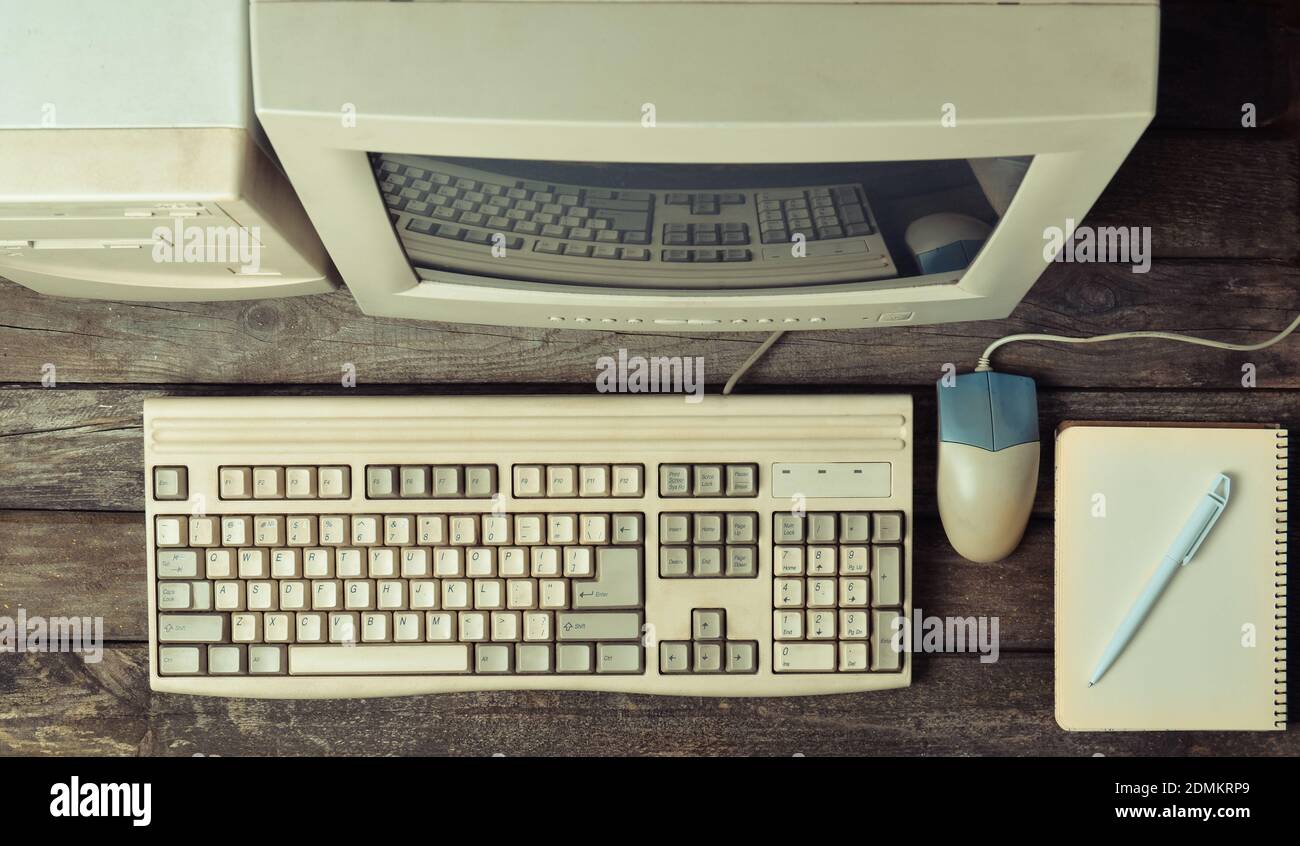 Retro stationary computer on a rustic wooden desk, vintage workspace ...