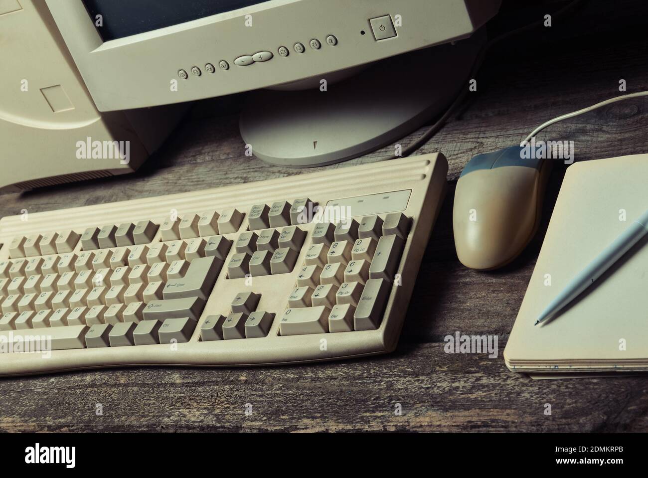 Retro stationary computer on a rustic wooden desk, vintage workspace ...
