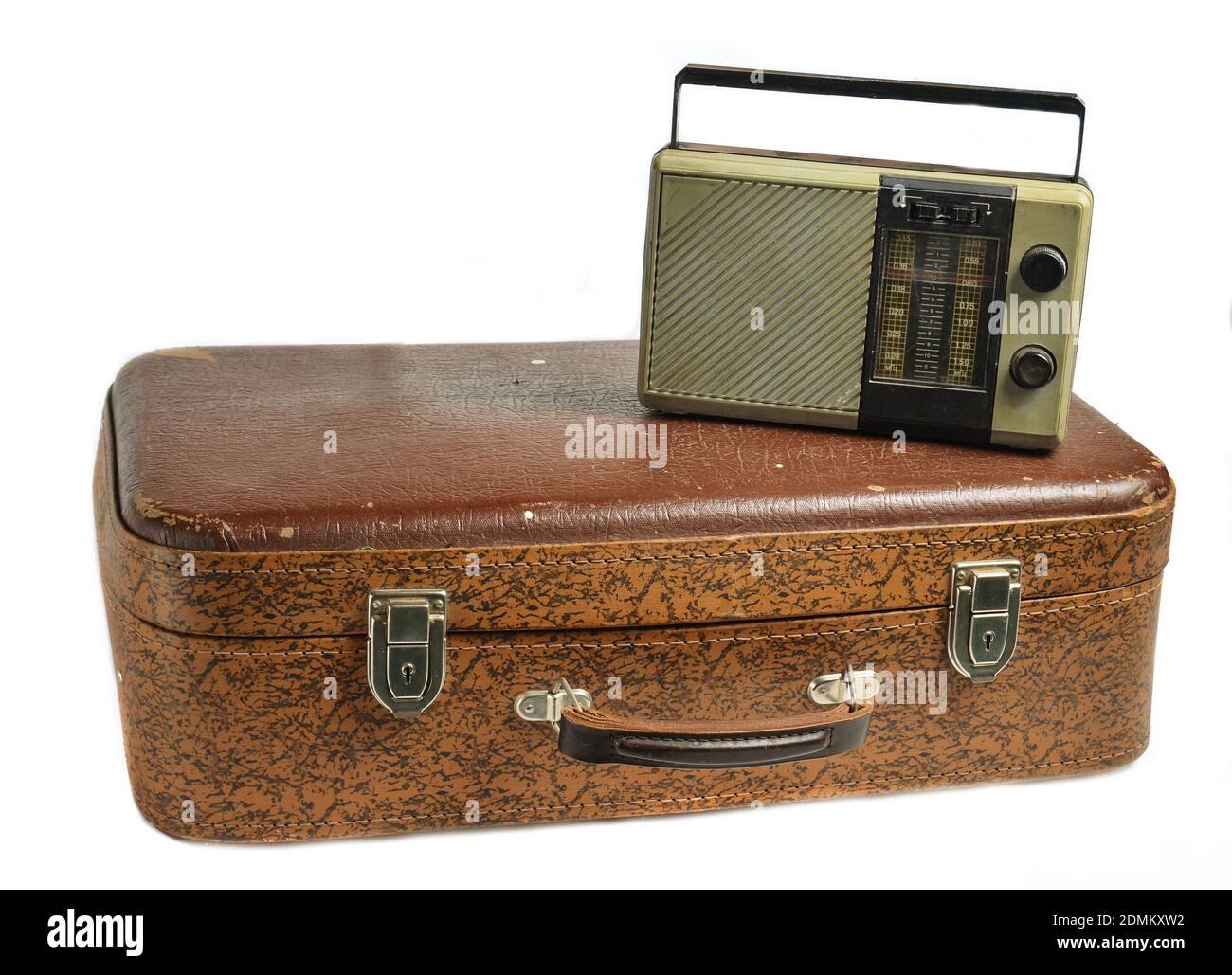 Retro radio receiver on old leather suitcase isolated on white ...