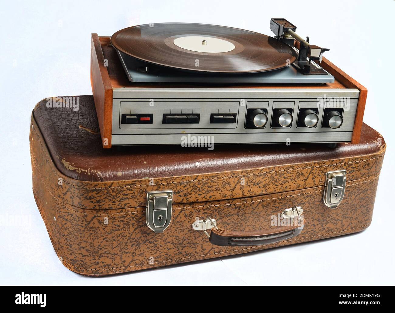 Vinyl player on an old leather suitcase isolated on a white background ...