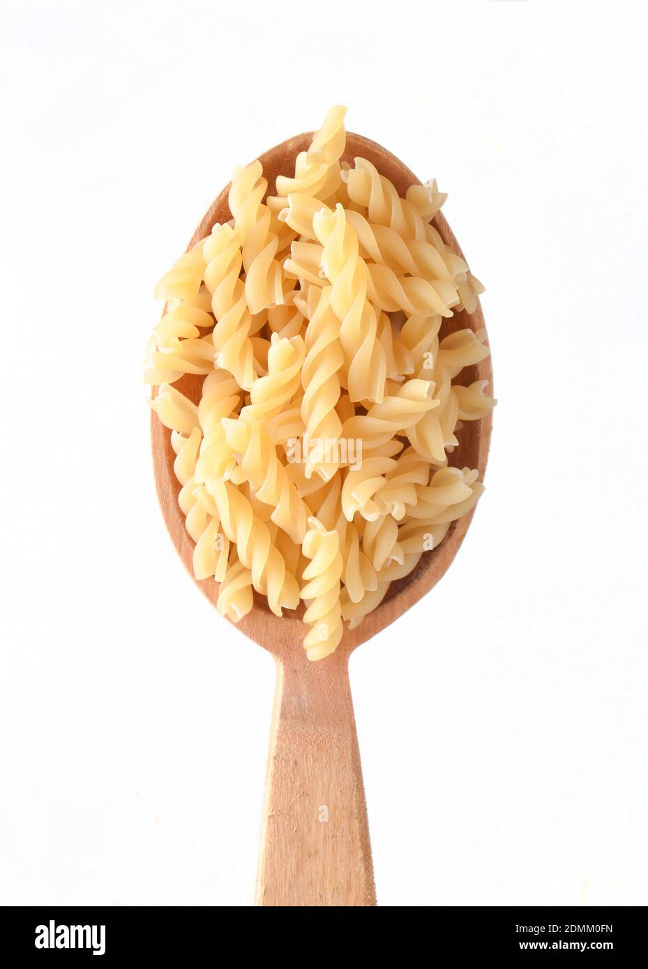 Wooden spoon with pasta isolated on white background Stock Photo - Alamy