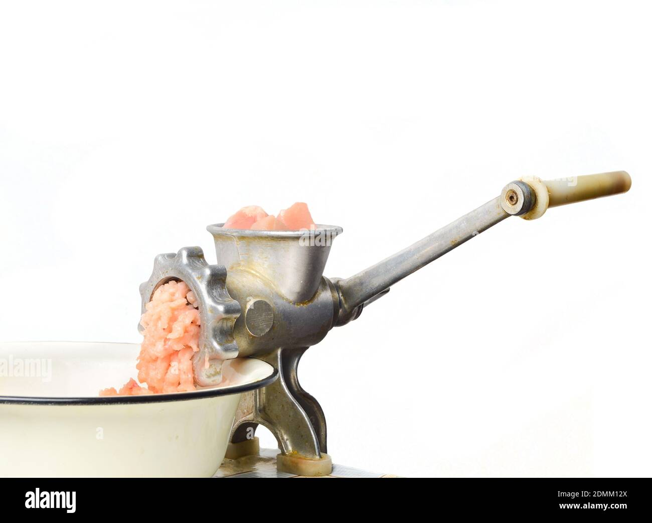 Vintage meat grinder grinds chicken meat isolated on white background ...
