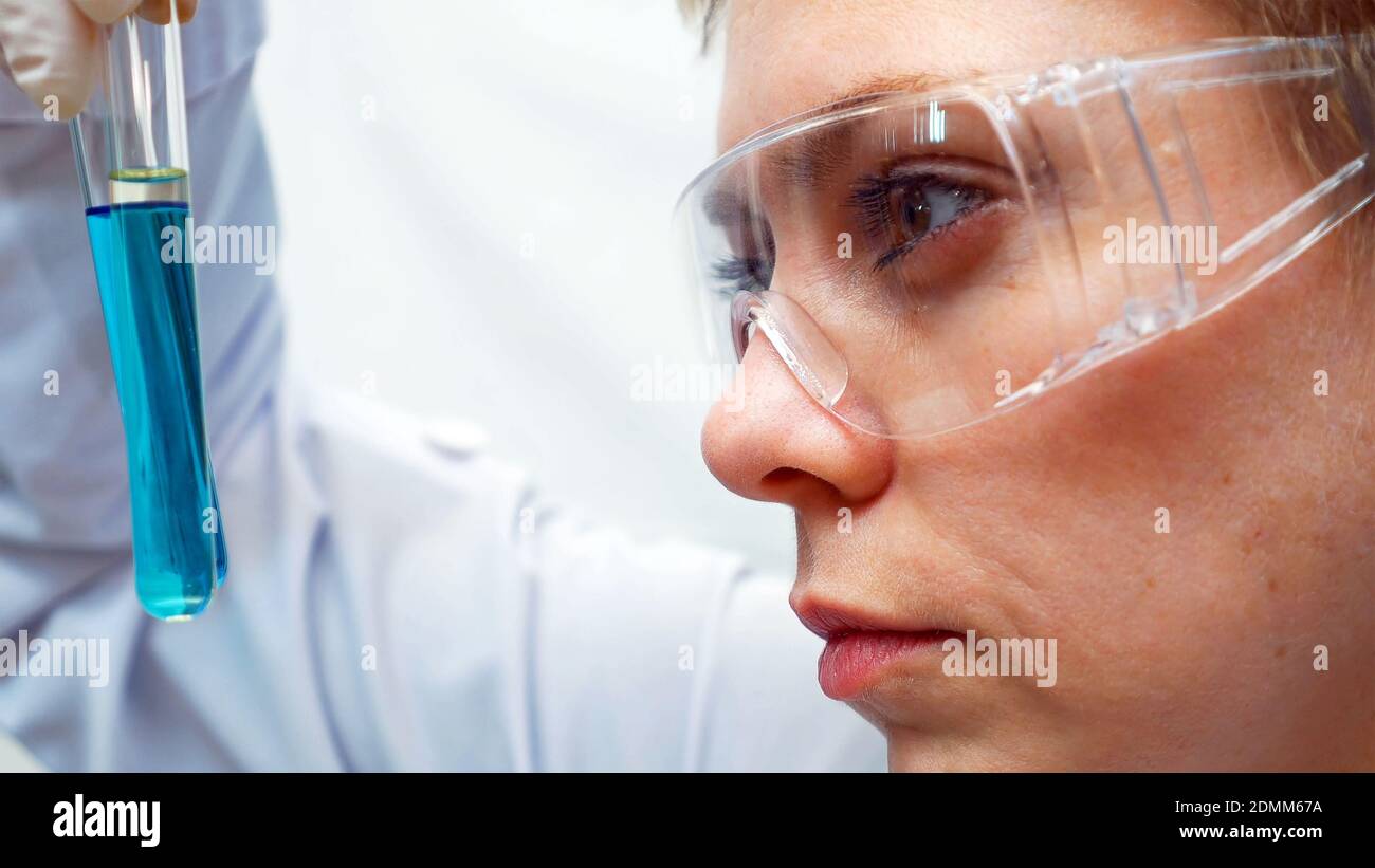 Scientist Looking At Test Tube Stock Photo - Alamy
