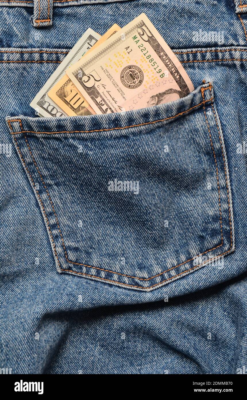 Dollar bills in the back pocket of rumpled jeans Stock Photo - Alamy