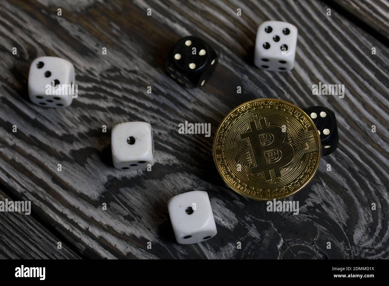 Bitcoin on black pine boards. Dice are scattered nearby Stock Photo - Alamy