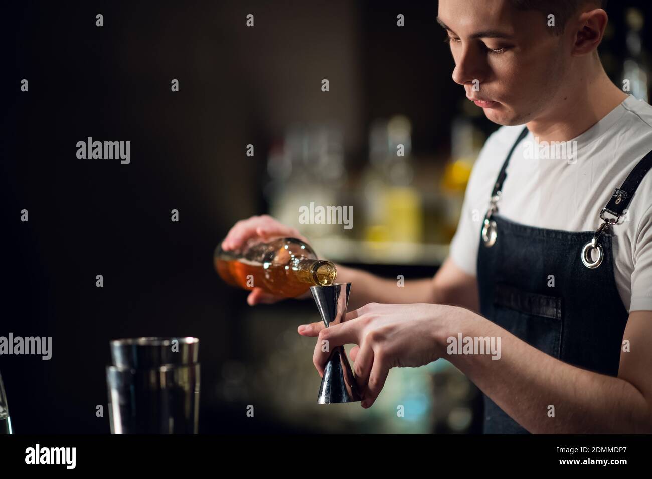 An experienced bartender prepares an alcoholic cocktail. No face, close ...