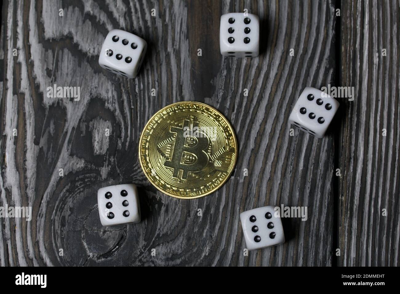 Bitcoin on black pine boards. Dice are scattered nearby Stock Photo - Alamy