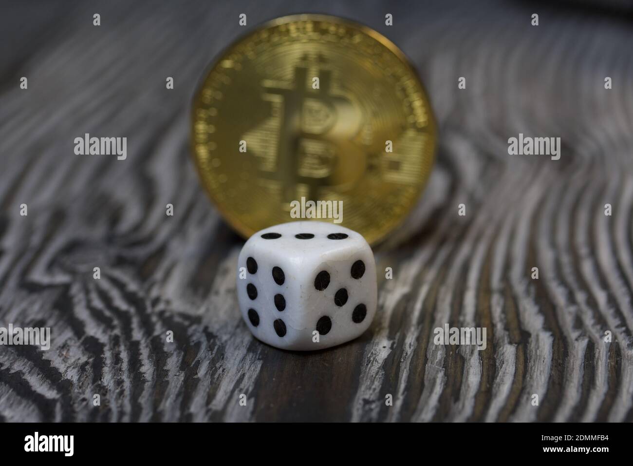 Bitcoin on black pine boards. Dice are scattered nearby Stock Photo - Alamy