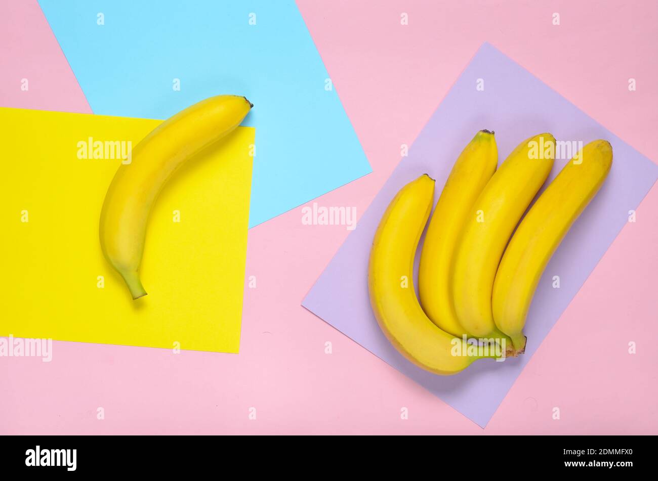 Ripe bananas on a colored paper background. Pastel color trend. The ...