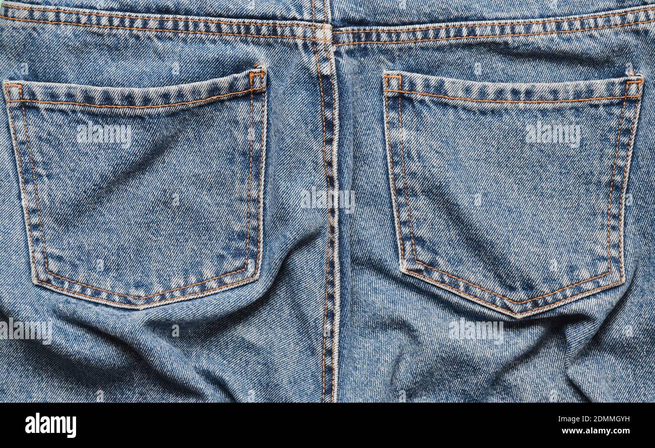 Texture of wrinkled jeans. Back pockets jeans Stock Photo - Alamy