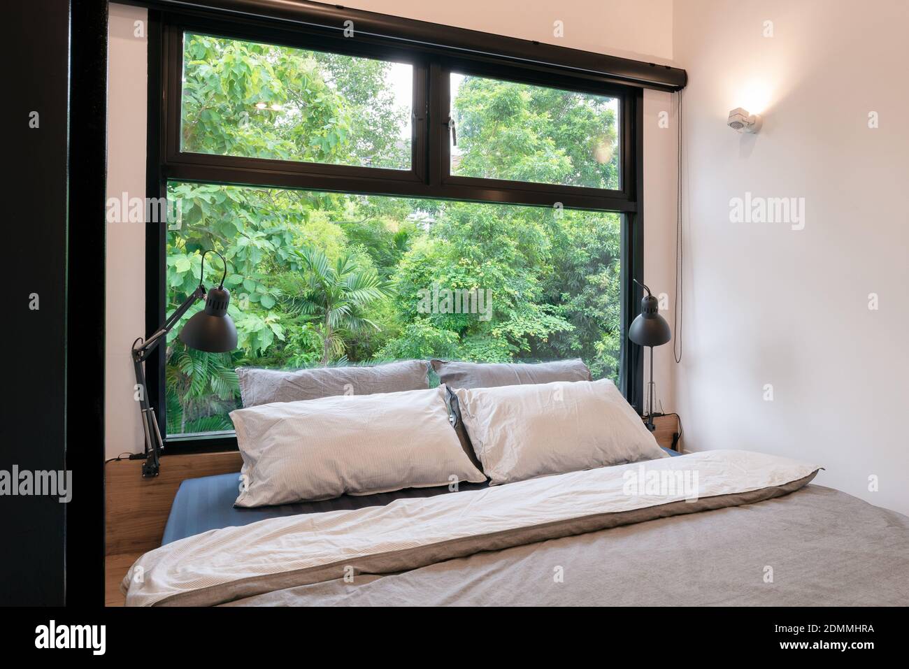 Bedroom with fresh nature green tree view through the window Stock ...