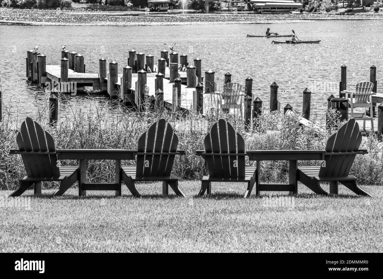 Chairs And Tables Sitting On Bench By Water Stock Photo - Alamy