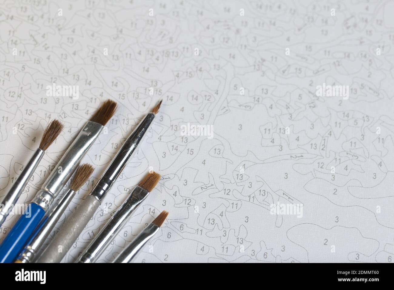 Paint brushes. On canvas with numbered sections. Drawing by numbers ...
