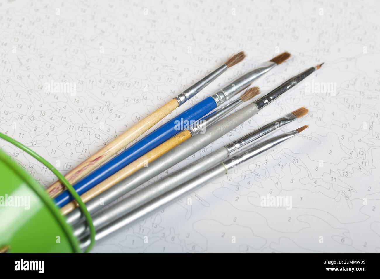 Paint brushes. On canvas with numbered sections. Drawing by numbers ...