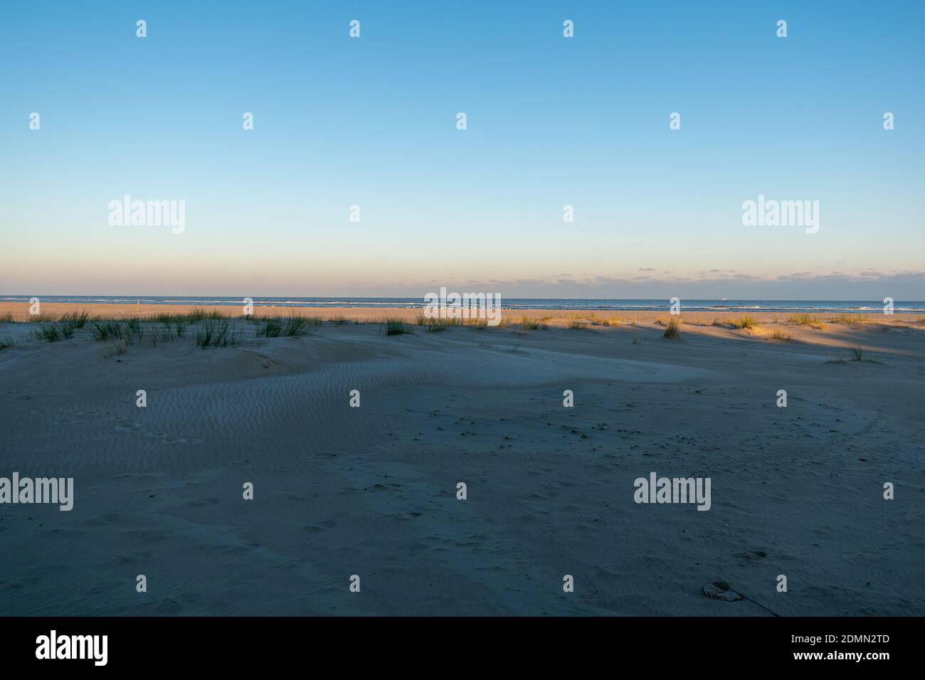 A sandy shore with a shadow on background of sea in Norderney Stock ...