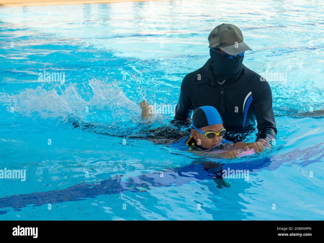 Instructor Teaching Swimming To Boy In Pool Stock Photo - Alamy
