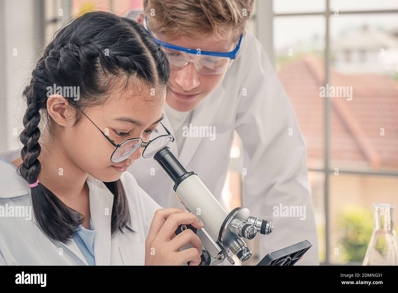 Students using microscope hi-res stock photography and images - Alamy