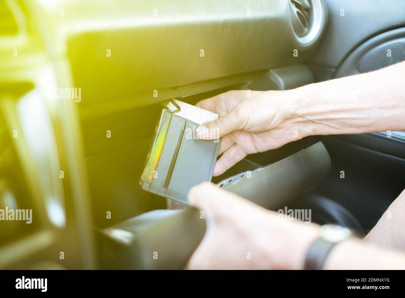 person's hand take wallet cash and credit card from the glove ...