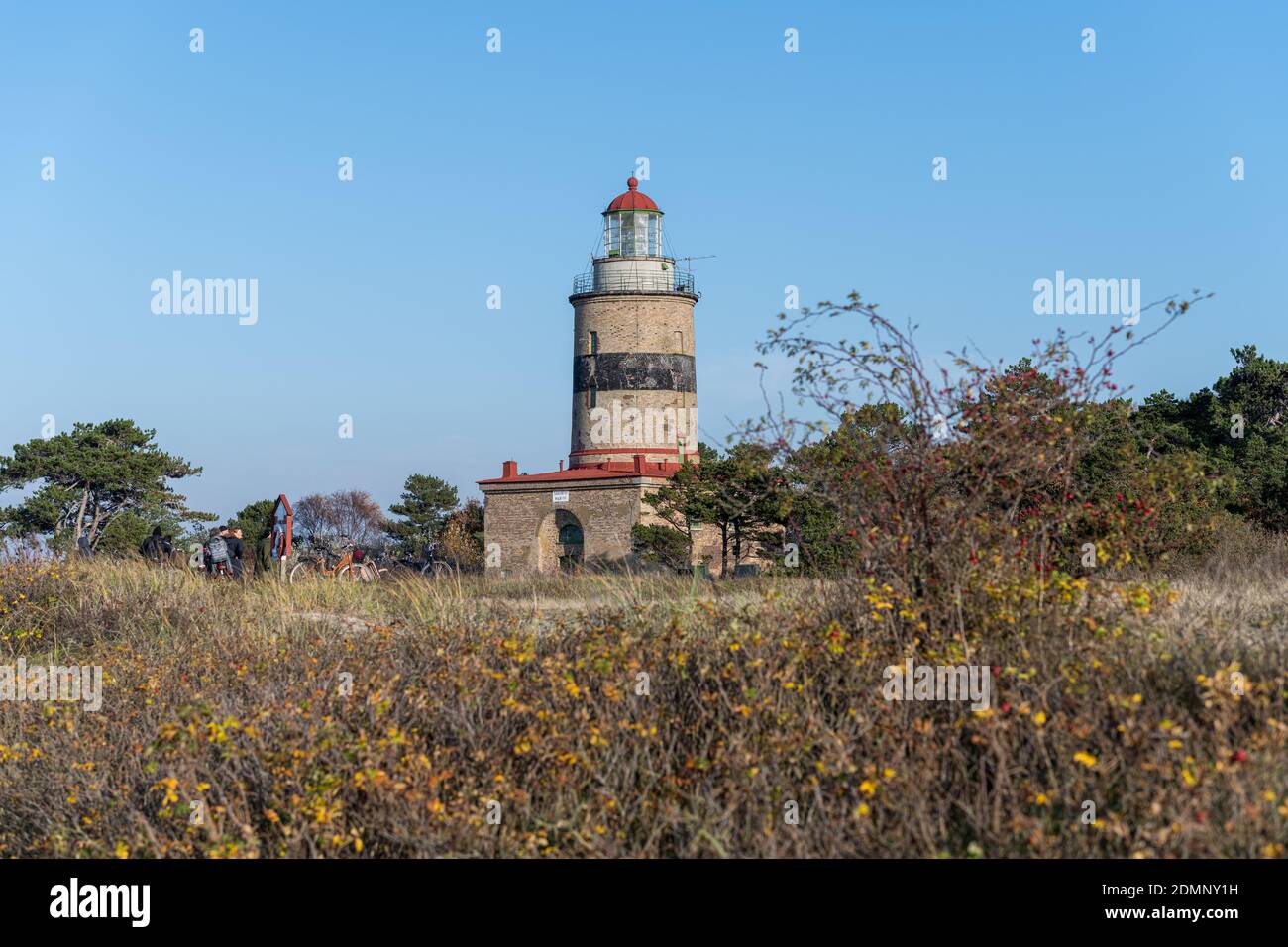 A brick lighthouse with a bright blue sky in the background. Picture of ...