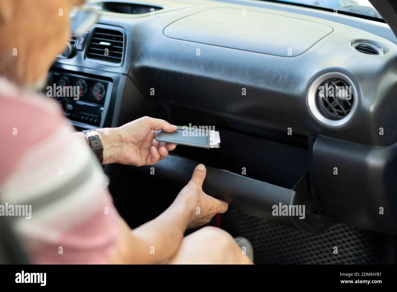 person's hand take wallet cash and credit card from the glove ...