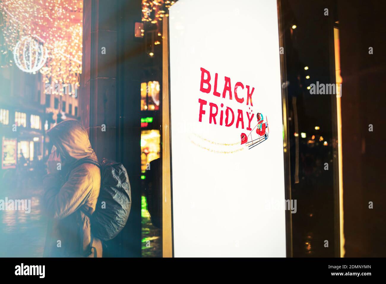 Black Friday signage on digital OOH display with unrecognizable man ...