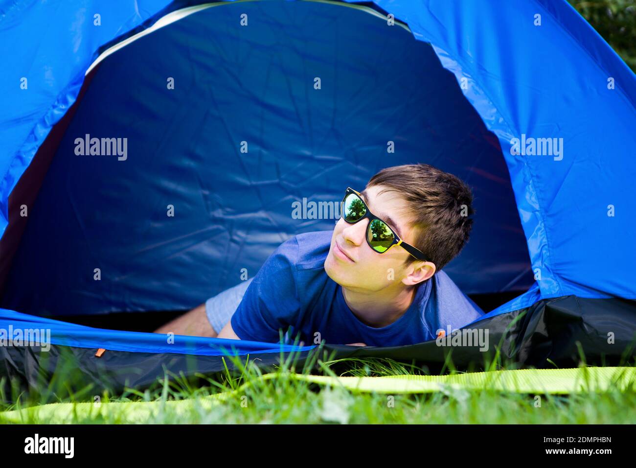 Young Man in the Tent Camping in the Nature Stock Photo - Alamy