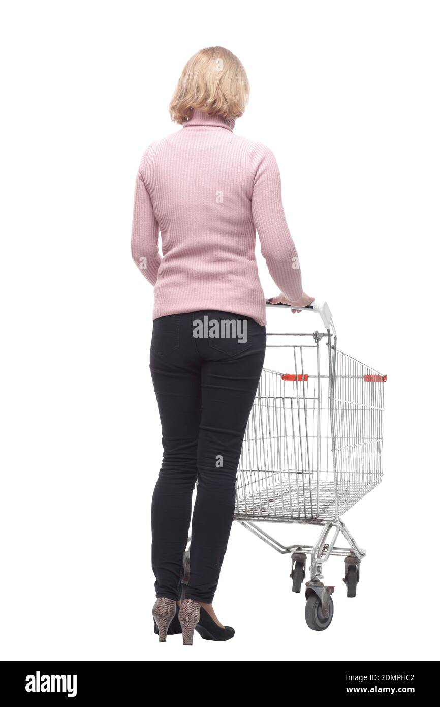 Rear view of casual woman with empty shopping cart on white background ...