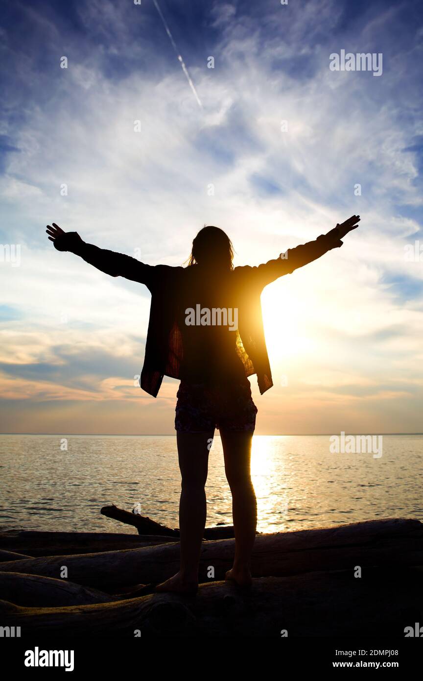 Happy Woman Silhouette with Hands Up on the Sunset Background Stock ...