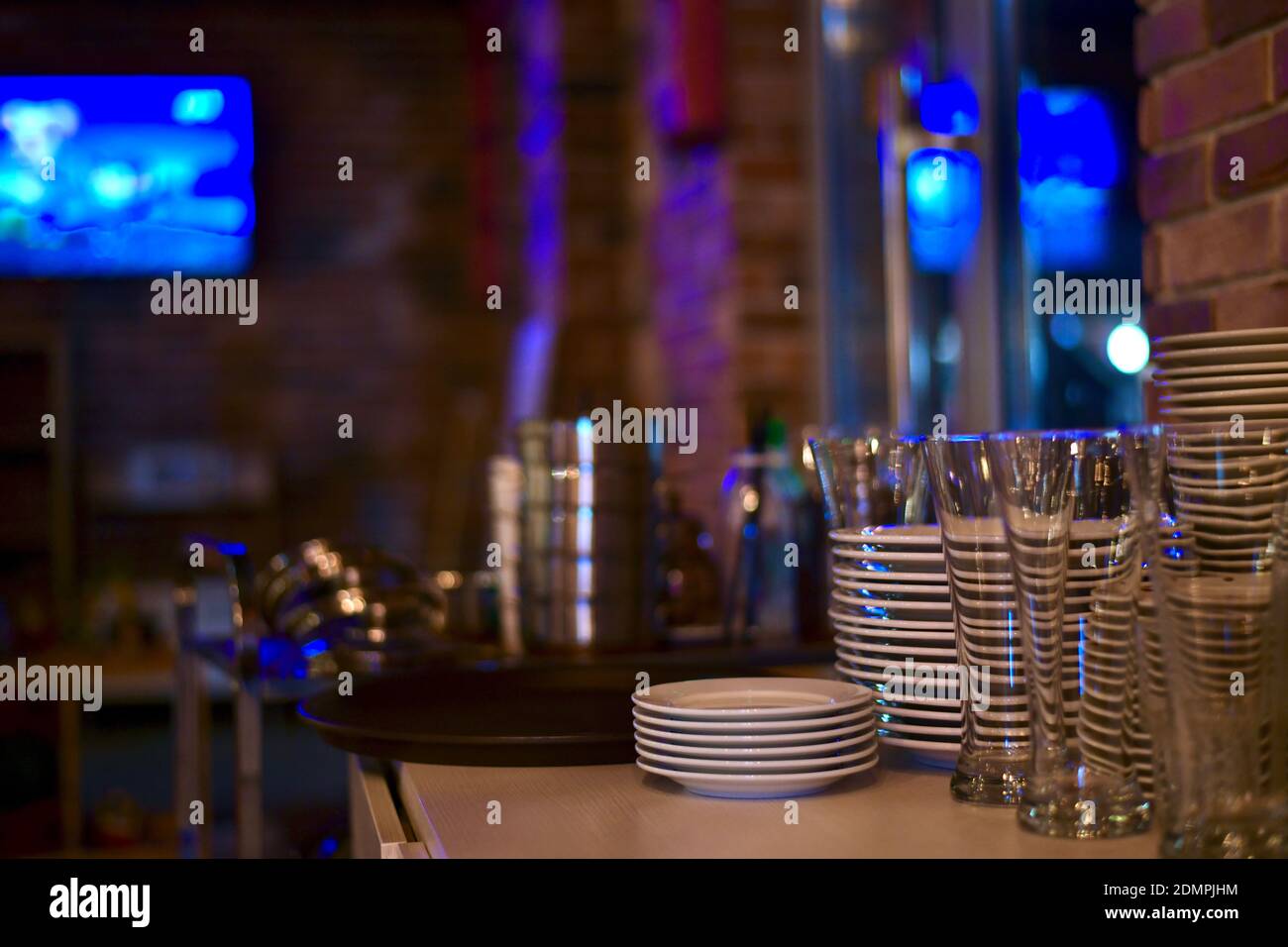Stacks of a clean shiny utensils made of steel, ceramics and glass. On ...