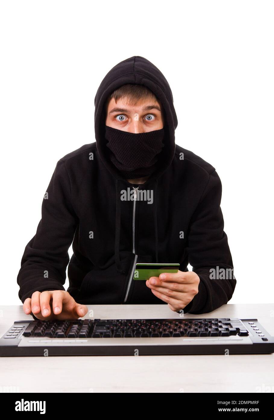 Surprised Hacker with a Bank Card and the Computer Keyboard on the ...