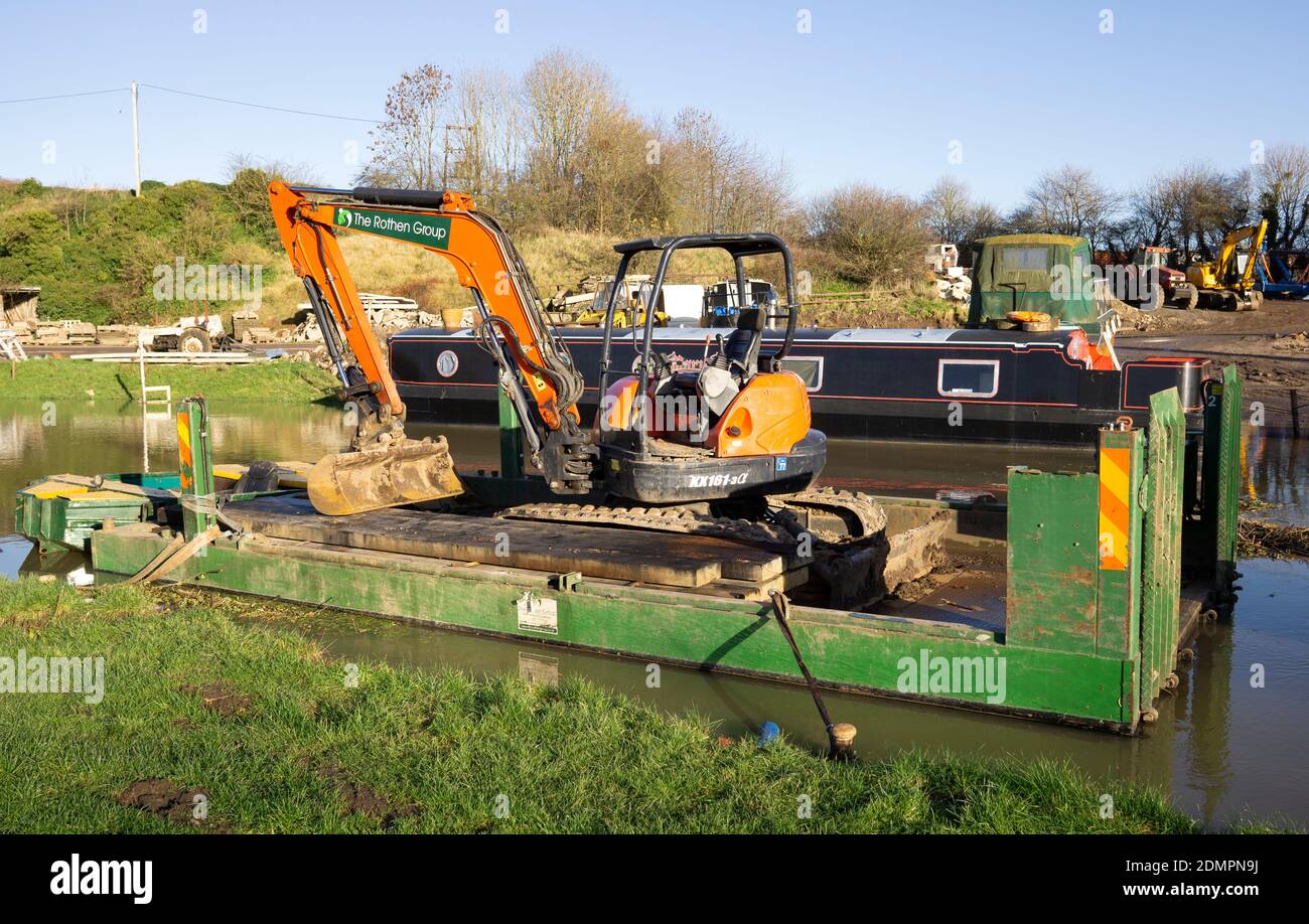 Small excavator on a barge Stock Photo - Alamy
