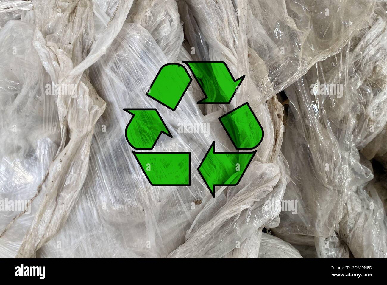 A green recycling icon on the waste plastic materials Stock Photo - Alamy