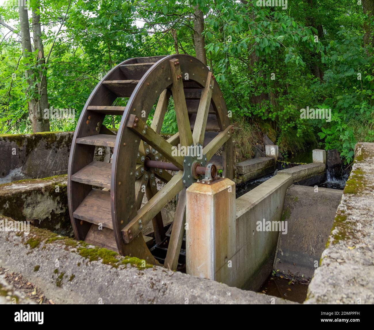 old rundown water wheel seen in the Bavarian Forest at summer time ...