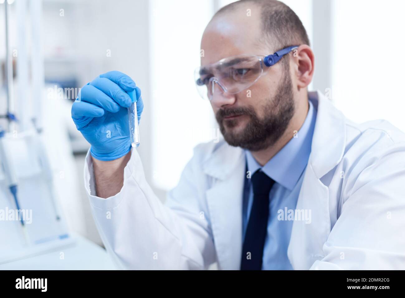 Concentrated scientist in laboraty conducting sample reseach ...