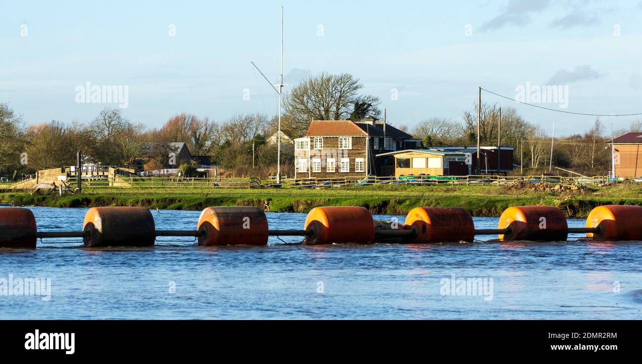 Orange safety boom across a river Stock Photo - Alamy